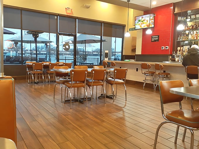 Classic orange vinyl chairs and warm wooden floors create that perfect diner atmosphere&mdash;nostalgic without trying too hard, like comfort food for your eyes.