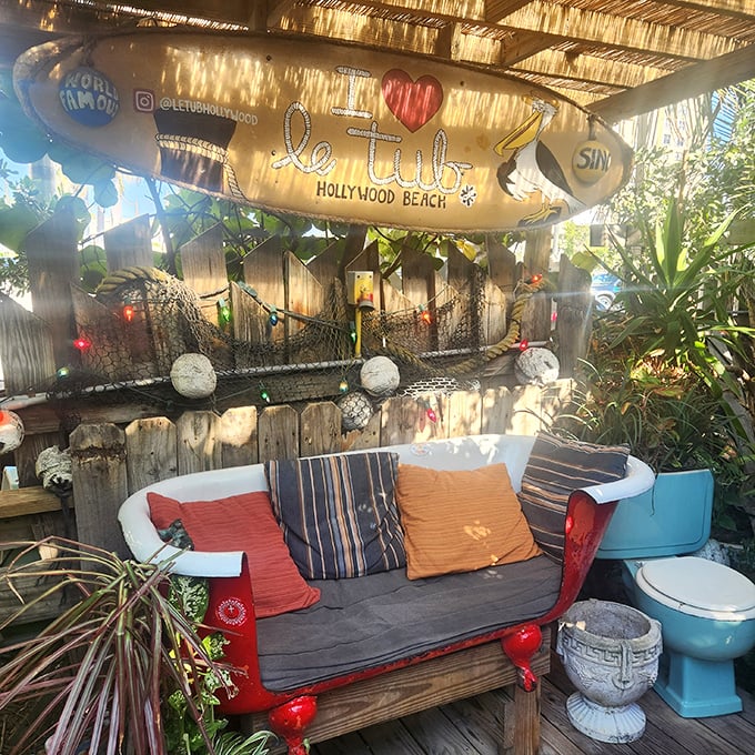 A bathtub sofa, toilet planters, and string lights create the kind of whimsical waterfront seating that makes you question conventional restaurant design&mdash;in the best possible way.