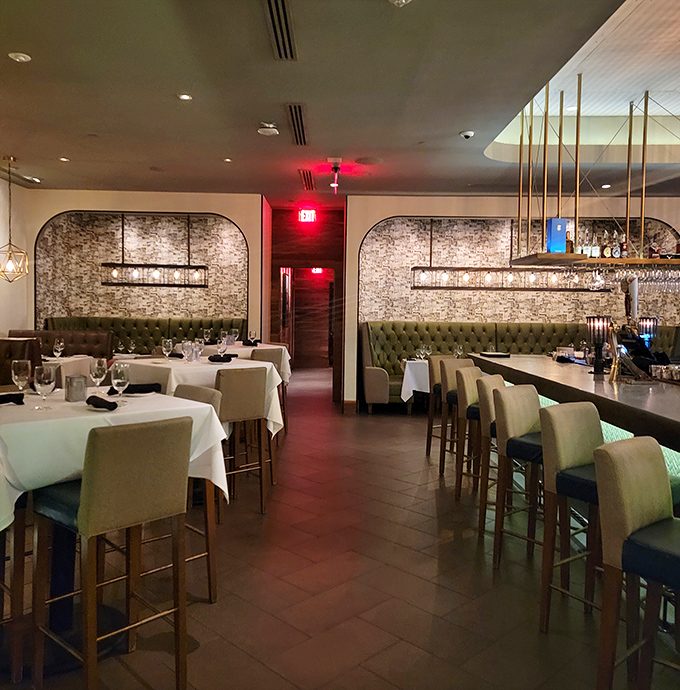 The dining room whispers "special occasion" with its stone walls and emerald banquettes, but regulars know any day deserves this level of comfort.