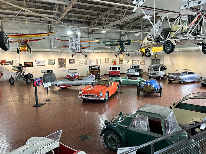 Where cars hang from the ceiling like mechanical bats and history parks itself on brick floors. It's automotive theater-in-the-round at its finest.