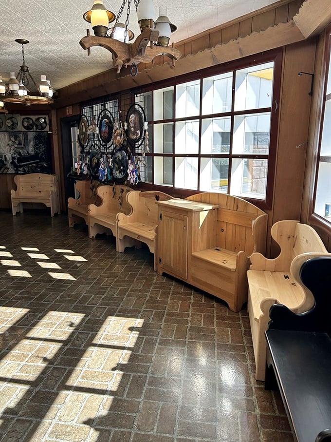 Handcrafted wooden furniture lines the interior, where sunlight creates a checkerboard dance across brick floors that have welcomed countless pie enthusiasts.