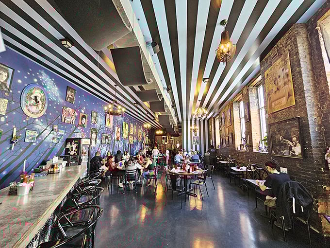Step inside and the magic continues with a striped ceiling, cosmic blue wall, and exposed brick that creates a space both whimsical and welcoming.