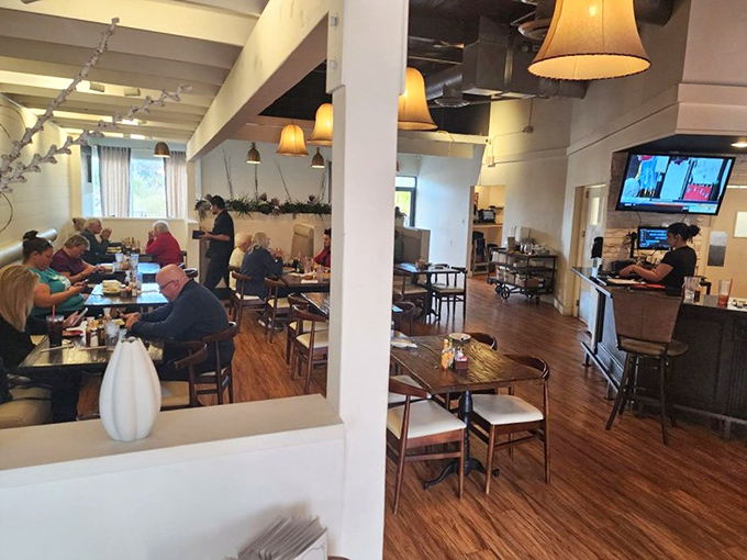 Warm wooden floors, soft pendant lighting, and a bustling dining room create that perfect "everybody knows your name" neighborhood restaurant vibe.