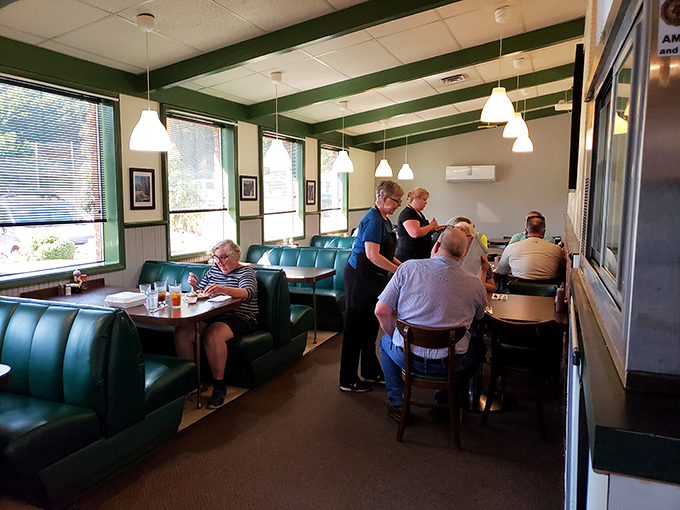 Classic teal booths cradle diners in comfort as pendant lights cast a warm glow. This isn't trendy dining&mdash;it's the timeless kind that makes you feel instantly at home.