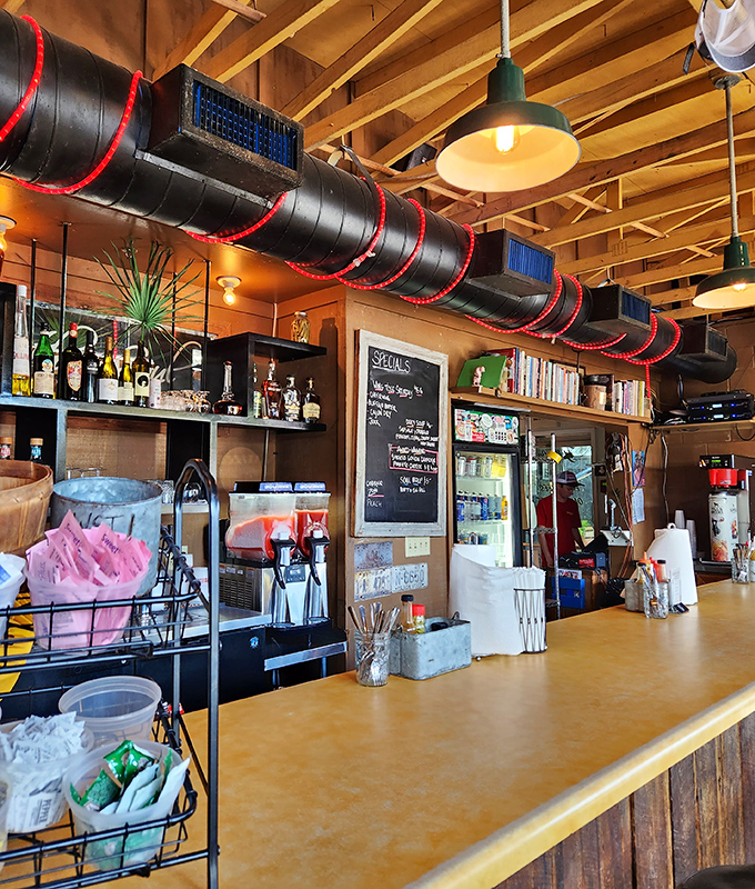 Industrial chic meets BBQ functionality. Those red-trimmed ventilation ducts aren't just for show—they're carrying the aromatic promises of oak-smoked goodness throughout.