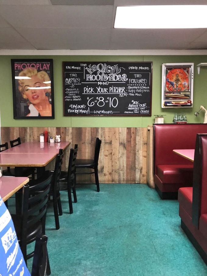 Retro charm meets comfort at its finest. The mint green walls, wooden paneling, and red vinyl booths create the perfect backdrop for morning revelations over coffee.