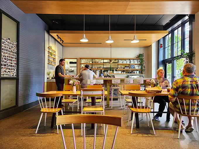 Inside, minimalist charm meets bagel paradise. Those wooden chairs aren't just seating—they're front-row tickets to the greatest show on carbs.