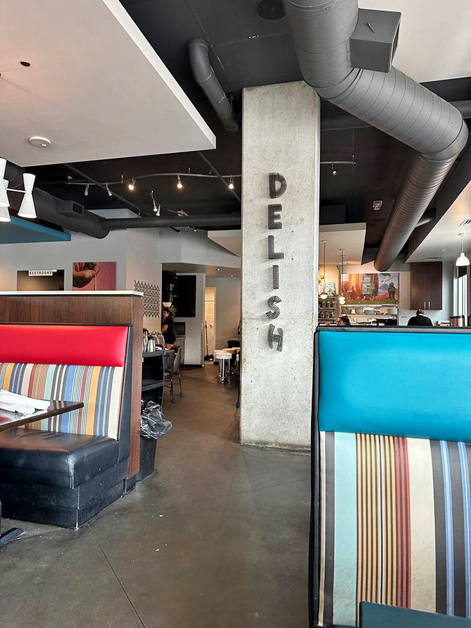 Industrial meets playful inside, where the concrete pillar boldly labeled "DELISH" serves as both structural support and accurate menu preview.