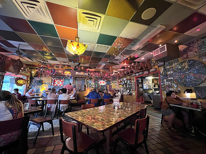 Dining under a patchwork sky of colorful ceiling tiles while surrounded by local art &ndash; Satchel's interior feels like falling into the creative side of Alice's wonderland.