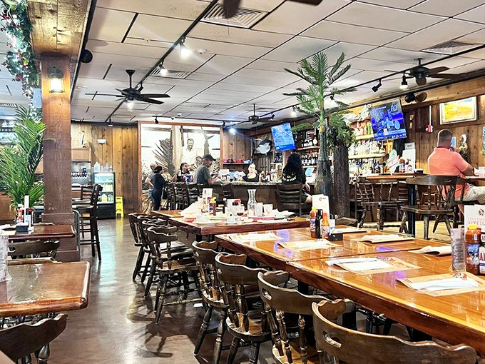 Wood-paneled warmth welcomes you like an old friend's kitchen. The ceiling fans don't just move air—they waft aromas of garlic and slow-roasted pork straight to your table.