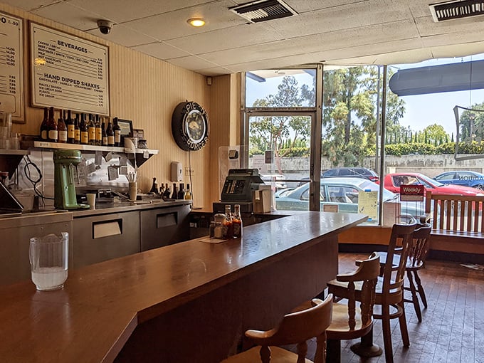 Pull up a stool at this L-shaped counter where strangers become friends and the wood-paneled walls have absorbed decades of satisfied sighs.