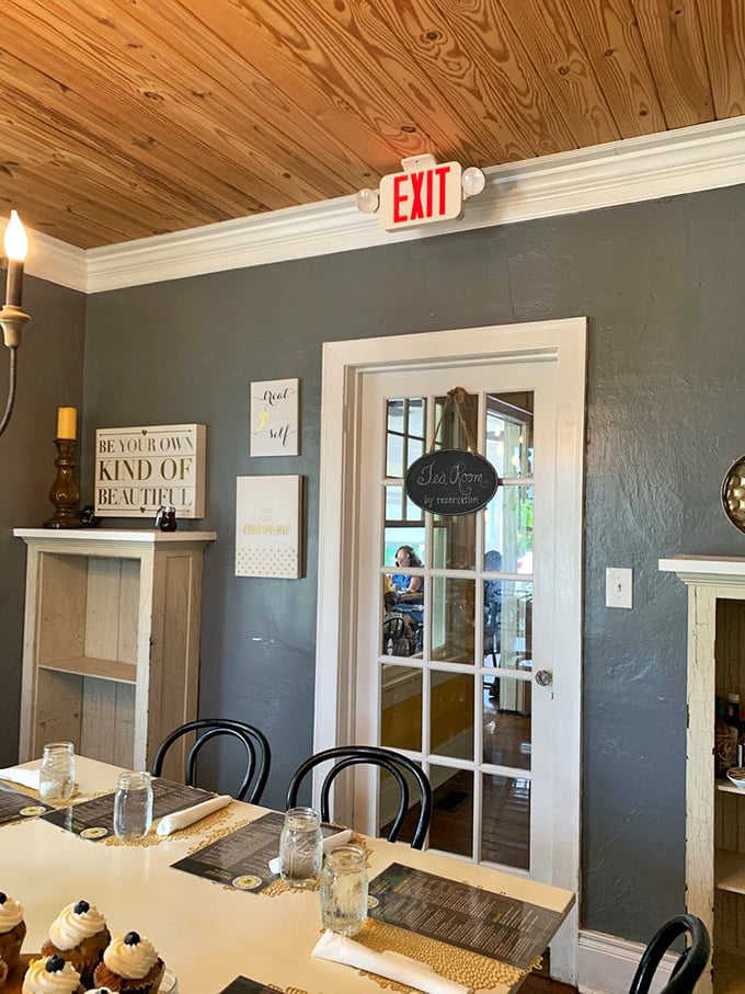 Rustic wooden ceilings meet soothing blue-gray walls in this cozy interior. The "Tea Room" sign hints at civilized indulgences beyond your standard breakfast joint.