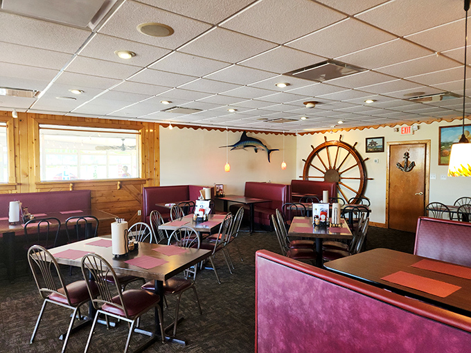 Ship wheels and burgundy booths create the perfect maritime backdrop. This dining room has witnessed countless "oohs" over perfectly fried seafood.