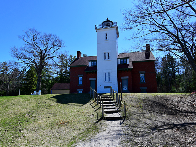 Standing tall against the blue Michigan sky, this lighthouse has been guiding ships safely through Lake Huron's waters since the late 1800s.