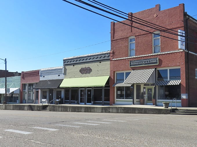 These classic brick storefronts have witnessed generations of Rector life, standing proud with their striped awnings like sentinels of small-town commerce.