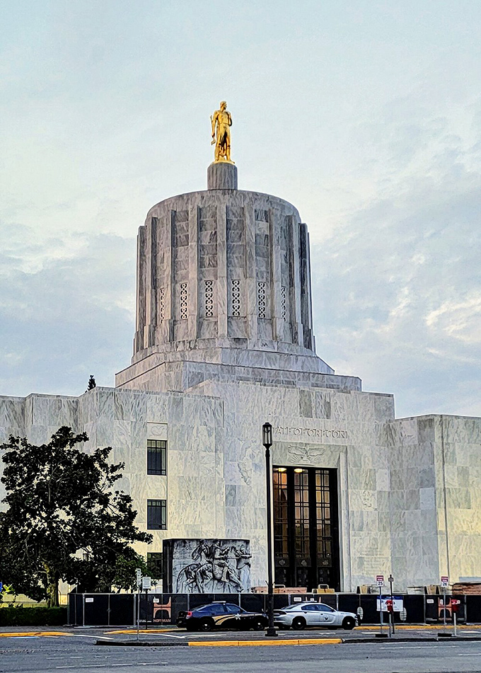The Oregon State Capitol's distinctive marble dome crowned with the Gold Pioneer statue stands as a gleaming beacon of civic pride and architectural splendor.
