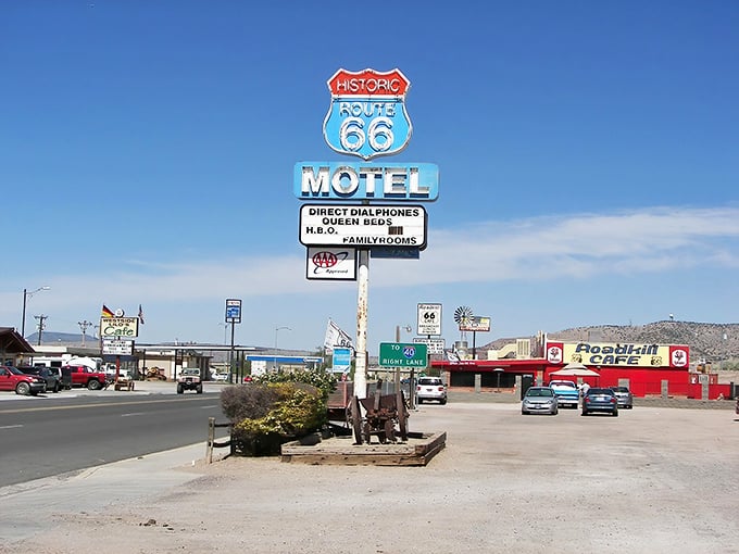 The Historic Route 66 Motel sign stands sentinel over Seligman, a neon beacon calling to road-trippers like moths to a particularly nostalgic flame.