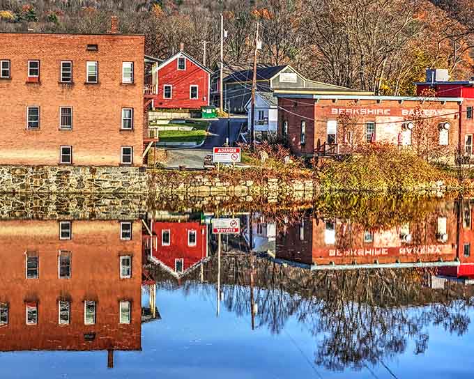 Brick buildings with character to spare, their autumn reflections dancing in the Deerfield River like nature's watercolor.