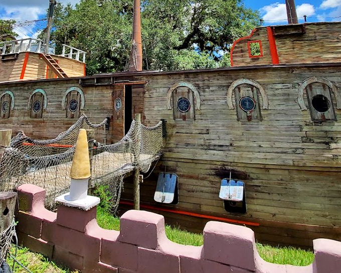 Not your average pirate ship! This wooden vessel serves as the "Boat in the Moat" restaurant, where landlubbers can feast without fear of walking the plank.