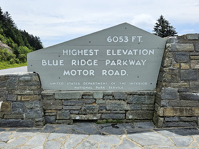 "6,053 feet above worries." This stone marker doesn't just show elevation—it's your official invitation to breathe mountain air that makes champagne feel jealous.