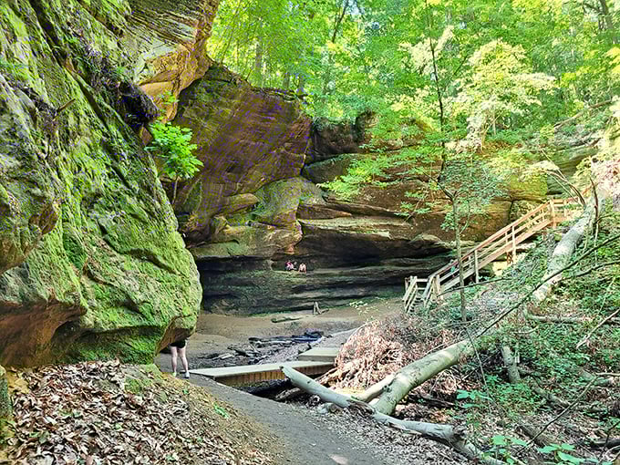 Nature's cathedral awaits around the bend. These ancient rock formations create cool, moss-covered sanctuaries perfect for contemplative moments away from summer heat.