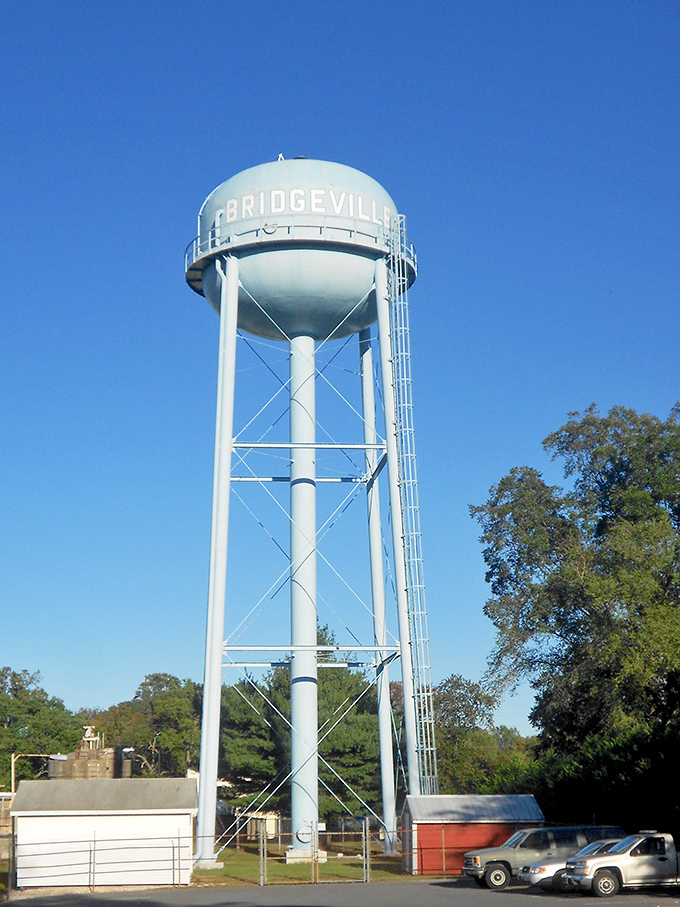 The iconic Bridgeville water tower stands sentinel against a perfect blue sky, announcing your arrival to this slice of small-town America.