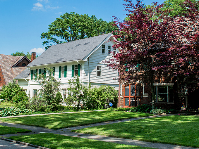 Manicured lawns and well-maintained homes create streetscapes that feel like they're straight out of a Norman Rockwell painting, minus the uncomfortable historical context.