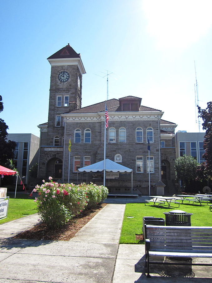 The Polk County Courthouse stands like a dignified elder statesman, its clock tower keeping watch over Dallas since 1900.