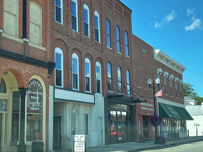 Brick buildings standing shoulder to shoulder like old friends. These storefronts have witnessed generations of small-town stories unfold beneath their ornate cornices.