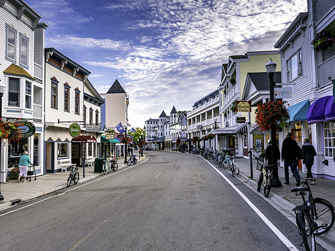 Downtown Mackinac under cotton candy clouds. The only traffic jam here involves horses, bicycles, and tourists hunting for the perfect fudge shop.