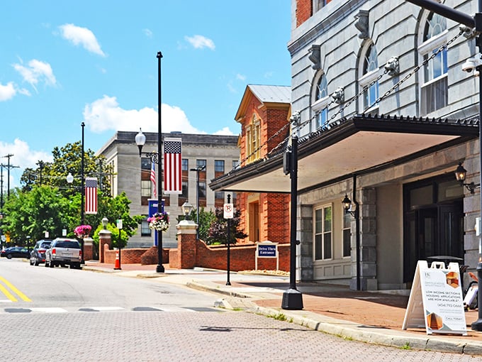 American flags flutter proudly along Danville's downtown district, where patriotism meets preservation in a streetscape that whispers stories of bygone eras.