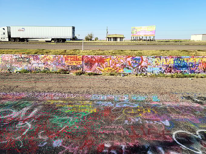The ground around Cadillac Ranch looks like a Jackson Pollock painting escaped the museum. Years of spray paint have transformed even the soil into art.