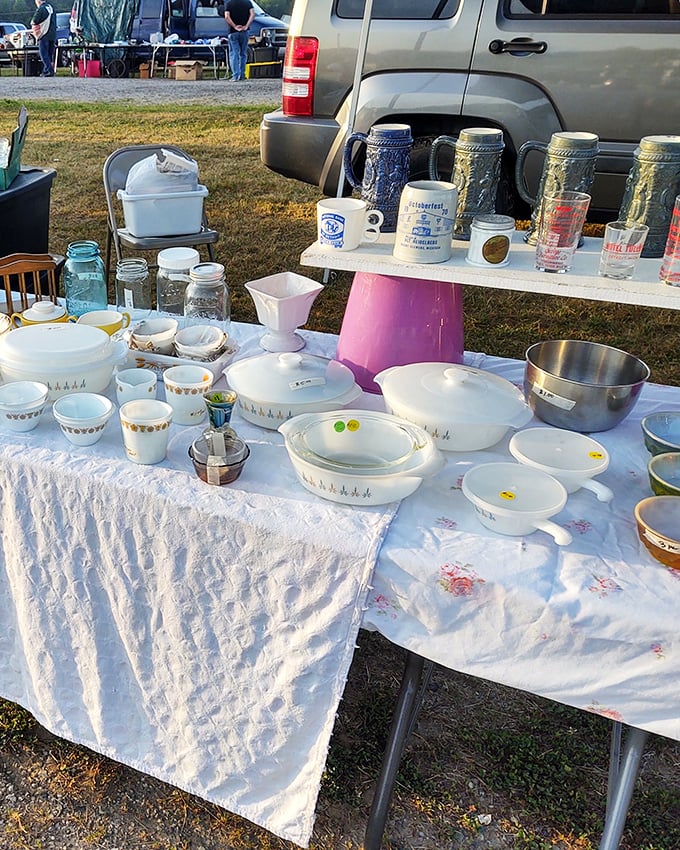 Grandma's kitchen cabinet exploded onto this table! Vintage Pyrex and mason jars waiting to start their second life in your home.
