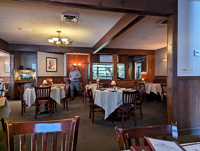 White tablecloths and wood-paneled walls create that perfect "special occasion that feels like home" atmosphere where memorable meals unfold.