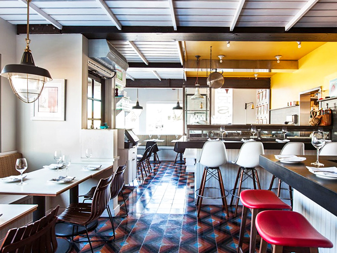 Step inside where nautical charm meets modern comfort, and every seat offers a front-row culinary show.