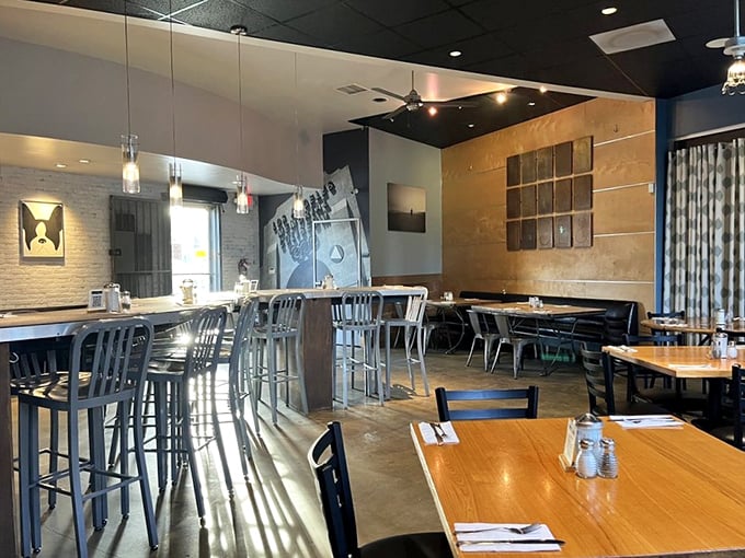 Modern meets cozy in this thoughtfully designed interior where breakfast dreams materialize amid pendant lighting and comfortable seating.