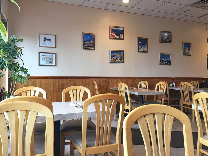 Mediterranean landscapes adorn walls above wooden wainscoting, creating that perfect "home away from home" atmosphere where conversations flow as freely as the coffee.