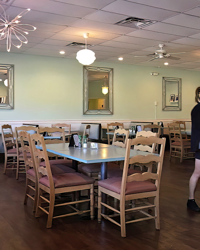 Mint green walls, wooden chairs, and thoughtful lighting create that rare diner atmosphere where you feel instantly at home yet somehow special.