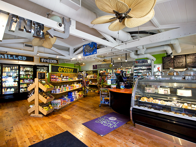 Tropical ceiling fans lazily stir the air while wooden shelves burst with provisions. This isn't just grocery shopping &ndash; it's a treasure hunt with delicious rewards.