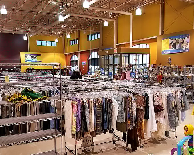 A sea of meticulously organized clothing racks stretches before you. The high ceilings and cheerful yellow walls make bargain hunting feel like a joyful expedition.