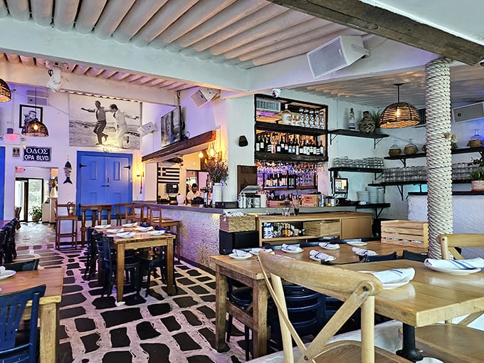 Step inside and you're transported to a Greek island taverna. White walls, rustic wood, and that unmistakable "something's about to happen" energy.