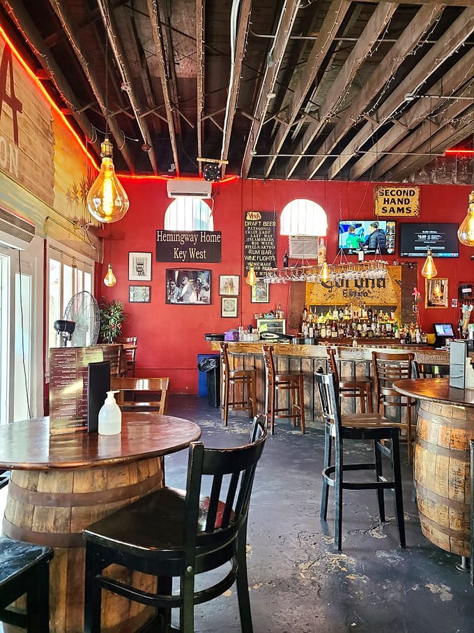 The interior's exposed beams and vibrant red walls create the perfect marriage between Key West casual and Argentine passion. Edison bulbs cast a warm glow over barrel tables.