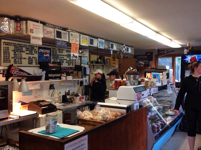 Behind this no-nonsense counter, culinary magic happens daily. The wall of memorabilia tells stories of satisfied customers who've made the pilgrimage for decades.