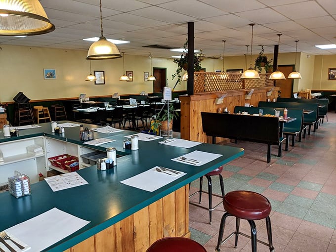 Classic diner geometry: wooden dividers, green-topped tables, and pendant lights creating that perfect "everybody knows your name" atmosphere.