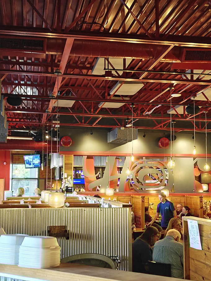Industrial meets rustic with those striking red ceiling beams&mdash;creating the perfect backdrop for serious eating and not-so-serious conversation.