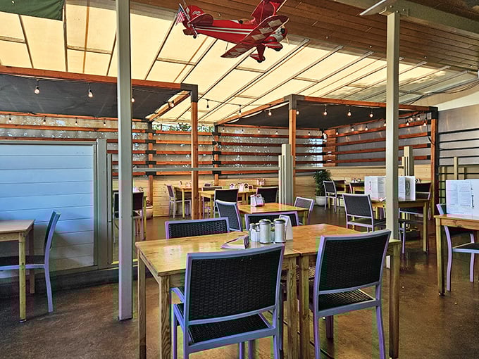 Inside, wooden tables and a model airplane hanging from the ceiling create that perfect balance of quirky charm and comfortable dining space.