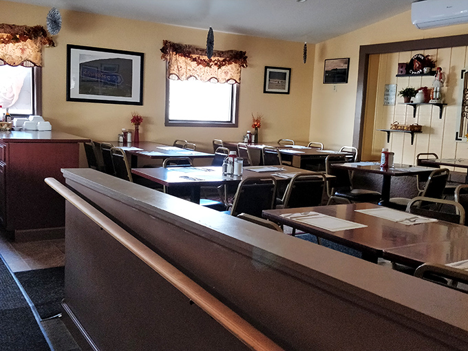 Inside, unpretentious charm awaits with clean tables, floral valances, and an atmosphere that whispers, "Sit down, relax, you're among friends now."