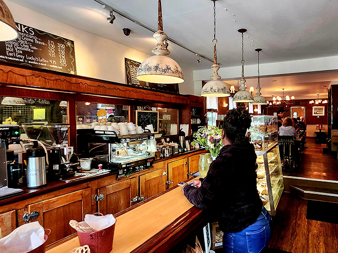 The wooden counter and vintage lighting create a warm, welcoming atmosphere where regulars and first-timers alike feel instantly at home.