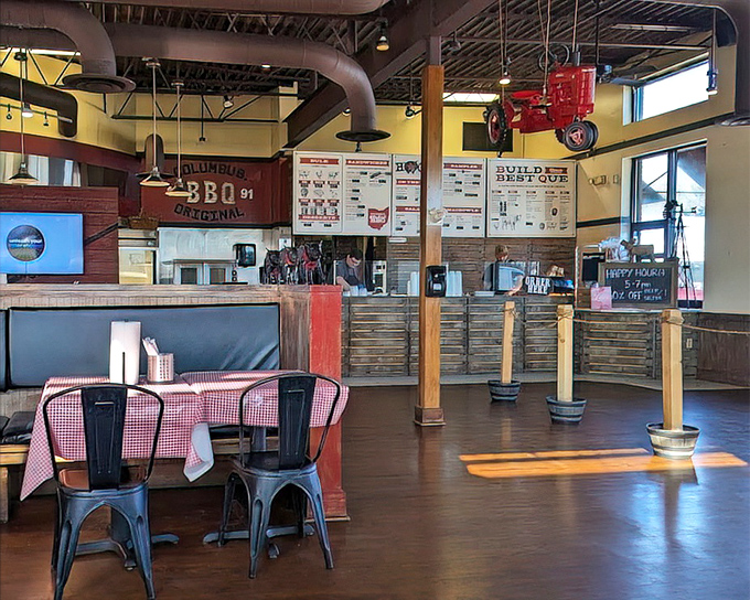 Industrial chic meets barbecue warmth inside Hoggy's, where the suspended tractor isn't just decor—it's a nod to Ohio's farming heritage.