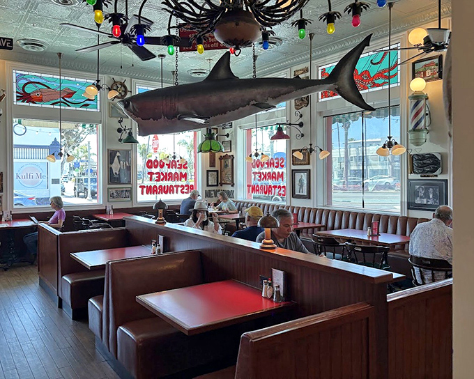 Inside, a shark hangs from the ceiling while diners enjoy their meals in wooden booths. Maritime kitsch never felt so authentically right.